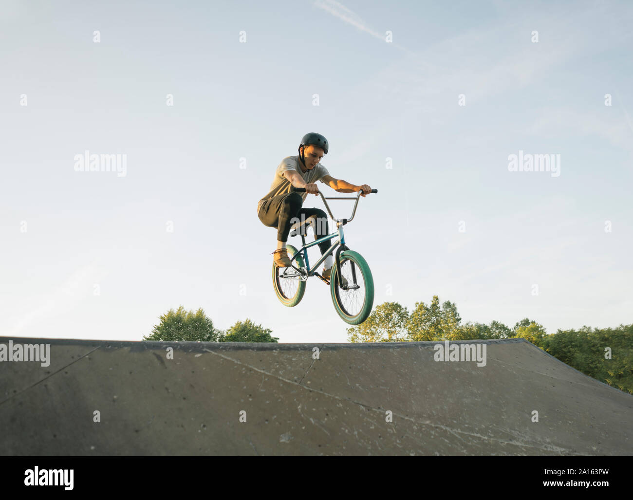Young man riding BMX bike at skatepark Stock Photo - Alamy