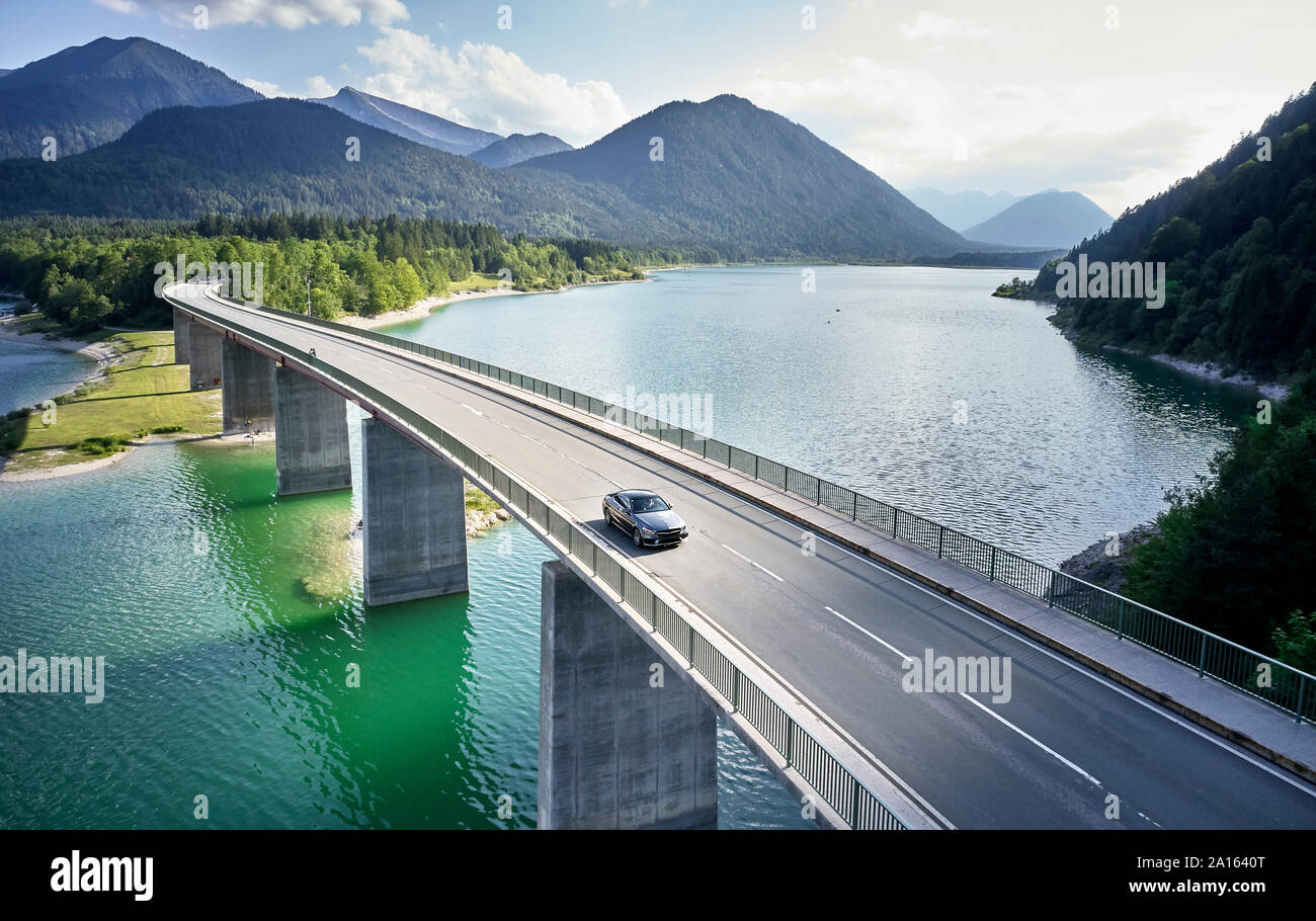 Aerial view of a car crossing a bridge, Sylvenstein Dam, Bavaria ...
