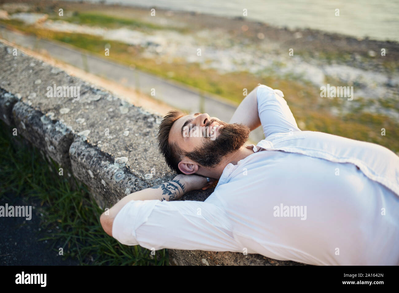 Man lying on a wall hi-res stock photography and images - Alamy