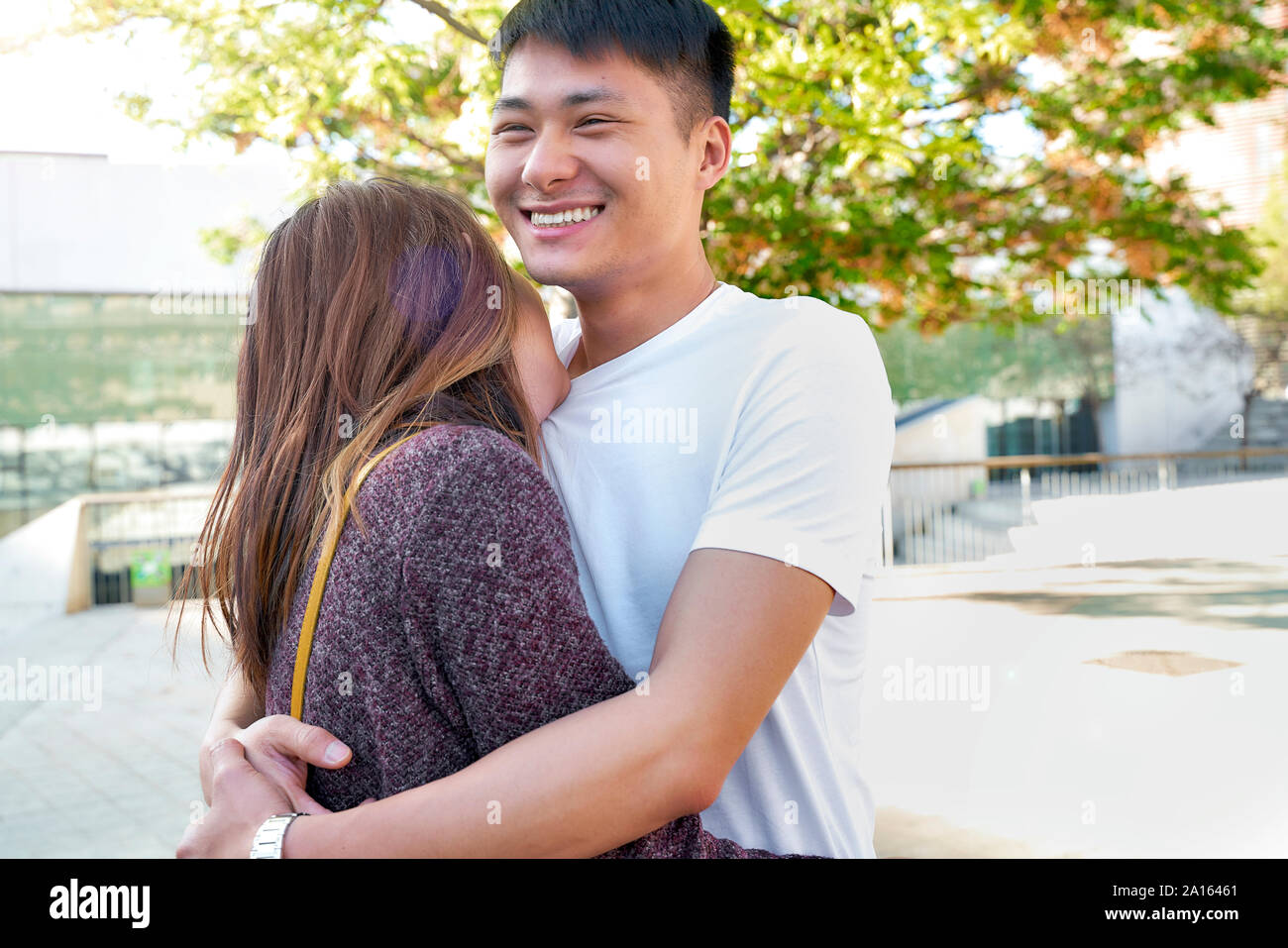 Asian couple hugging outdoors hi-res stock photography and images - Alamy