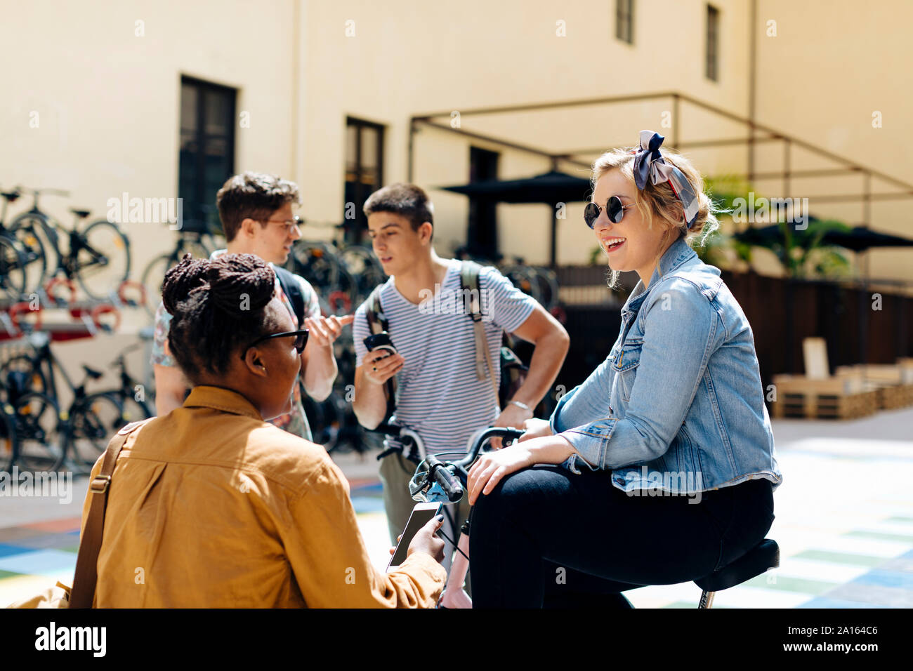 Students meeting in a backyard, talking, unsing smartphones Stock Photo ...