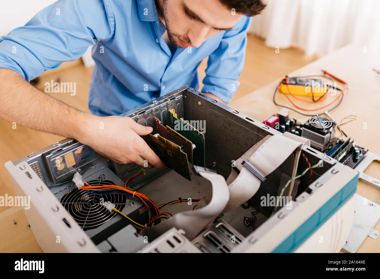 Technician repairing a desktop computer, changing circuit board Stock ...