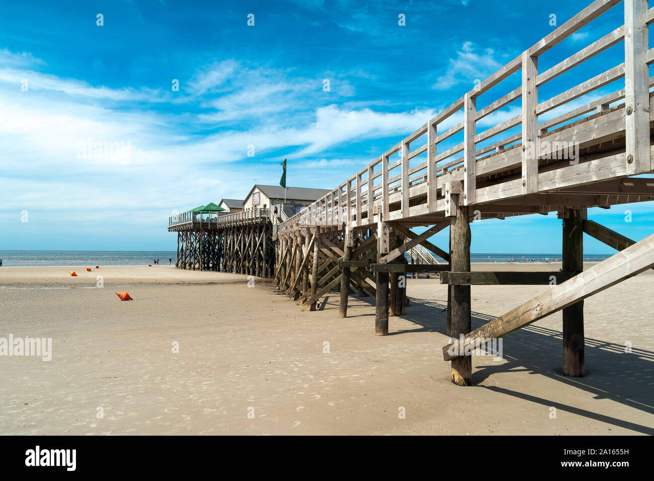 Beach with bridge and stilt houses at low tide hi-res stock photography ...