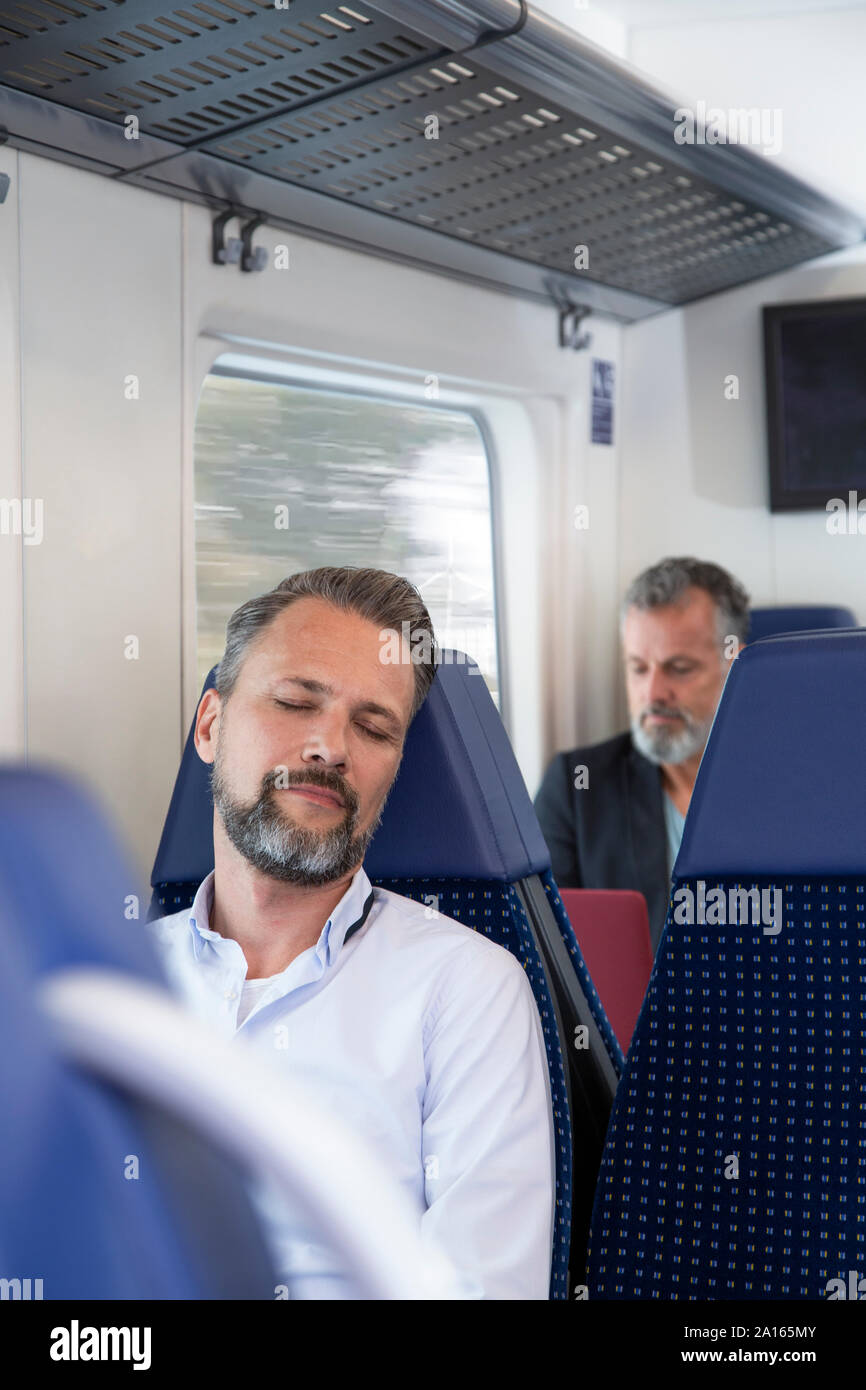 Two men sitting in train hi-res stock photography and images - Alamy