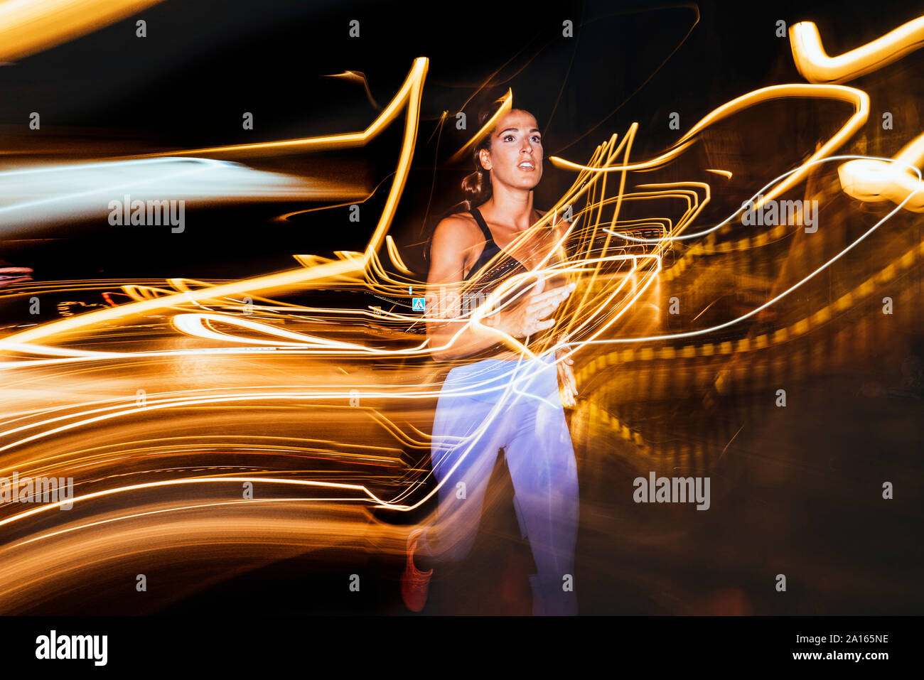 Woman running at night hi-res stock photography and images - Alamy