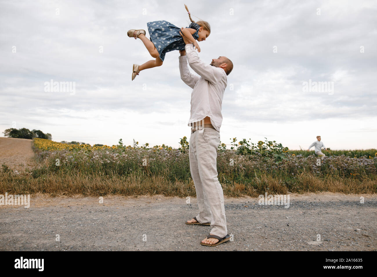 Father playing with his daughter, holding her aloft Stock Photo - Alamy
