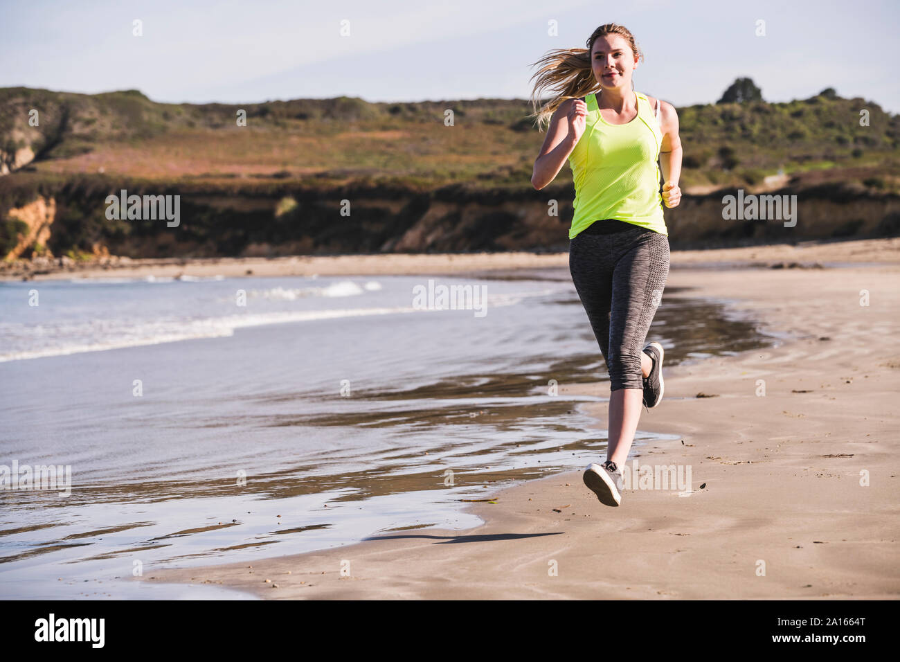 Female jogger at the beach Stock Photo - Alamy