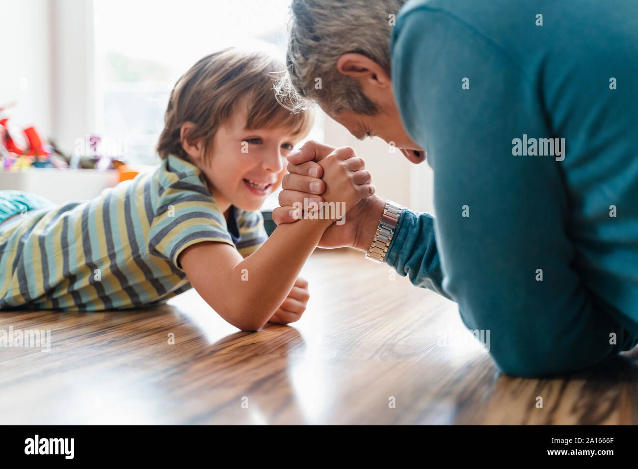 Father son arm wrestling home hi-res stock photography and images - Alamy