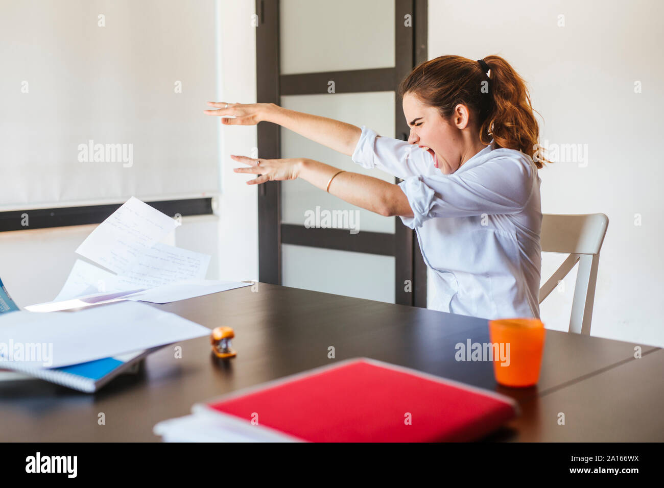Angry female student at desk at home Stock Photo - Alamy