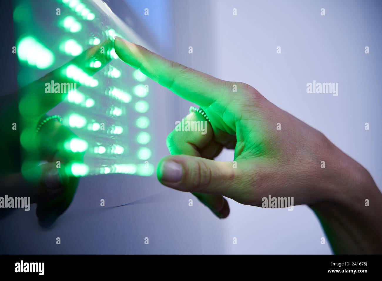Detail of finger touching green led touchscreen Stock Photo - Alamy