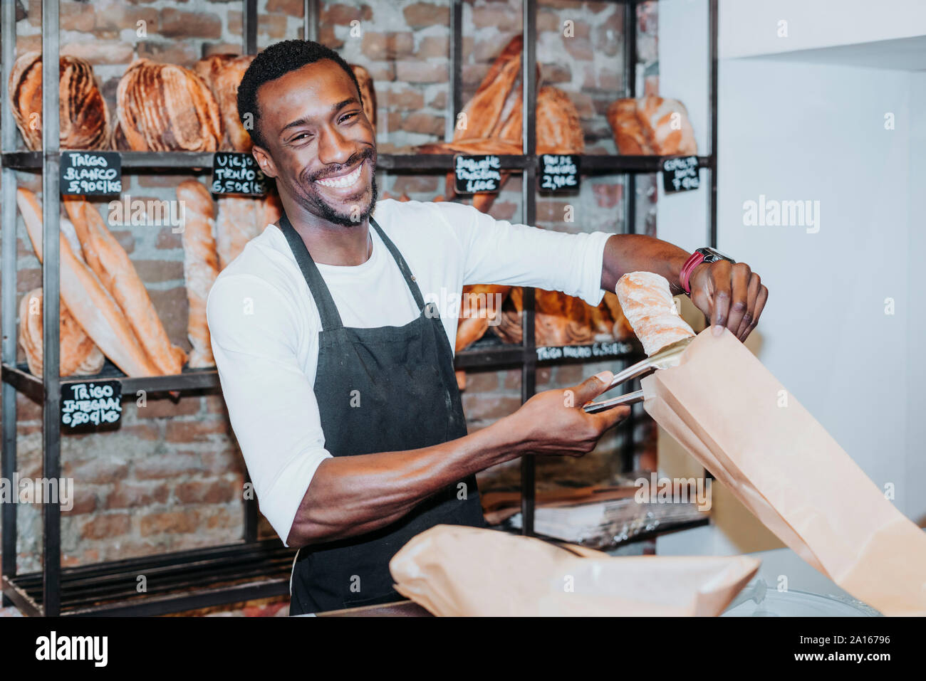 Person with a baguette in bakery hi-res stock photography and images ...