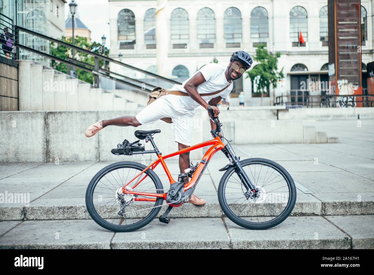 Bicycle courier getting on his bike Stock Photo - Alamy