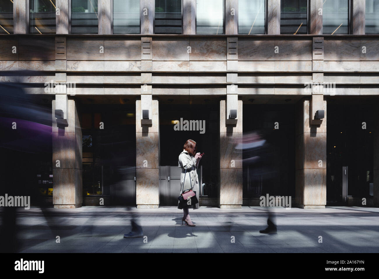 Woman standing in crowd of people hi-res stock photography and images ...