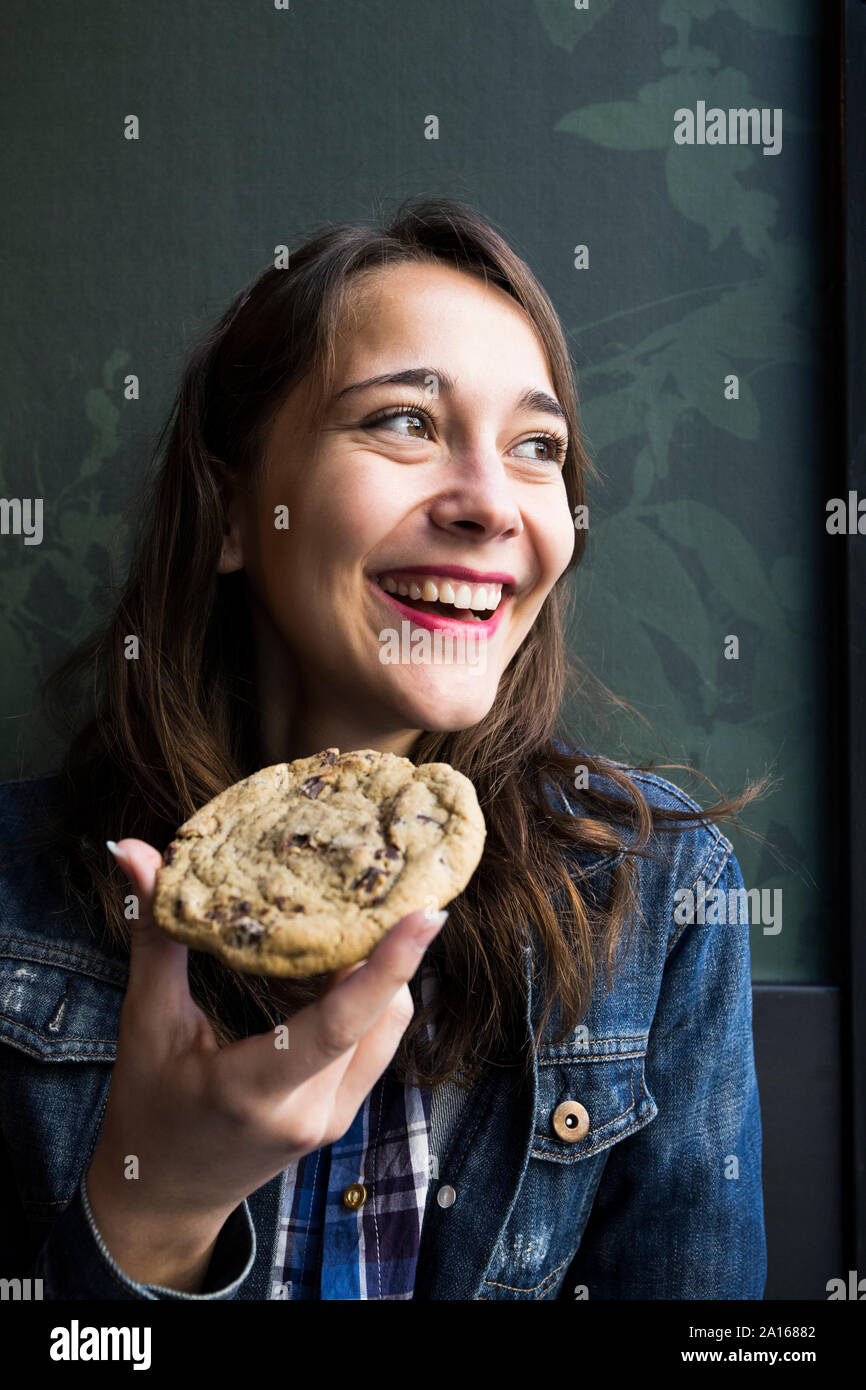 Woman eating chocolate biscuit hi-res stock photography and images - Alamy
