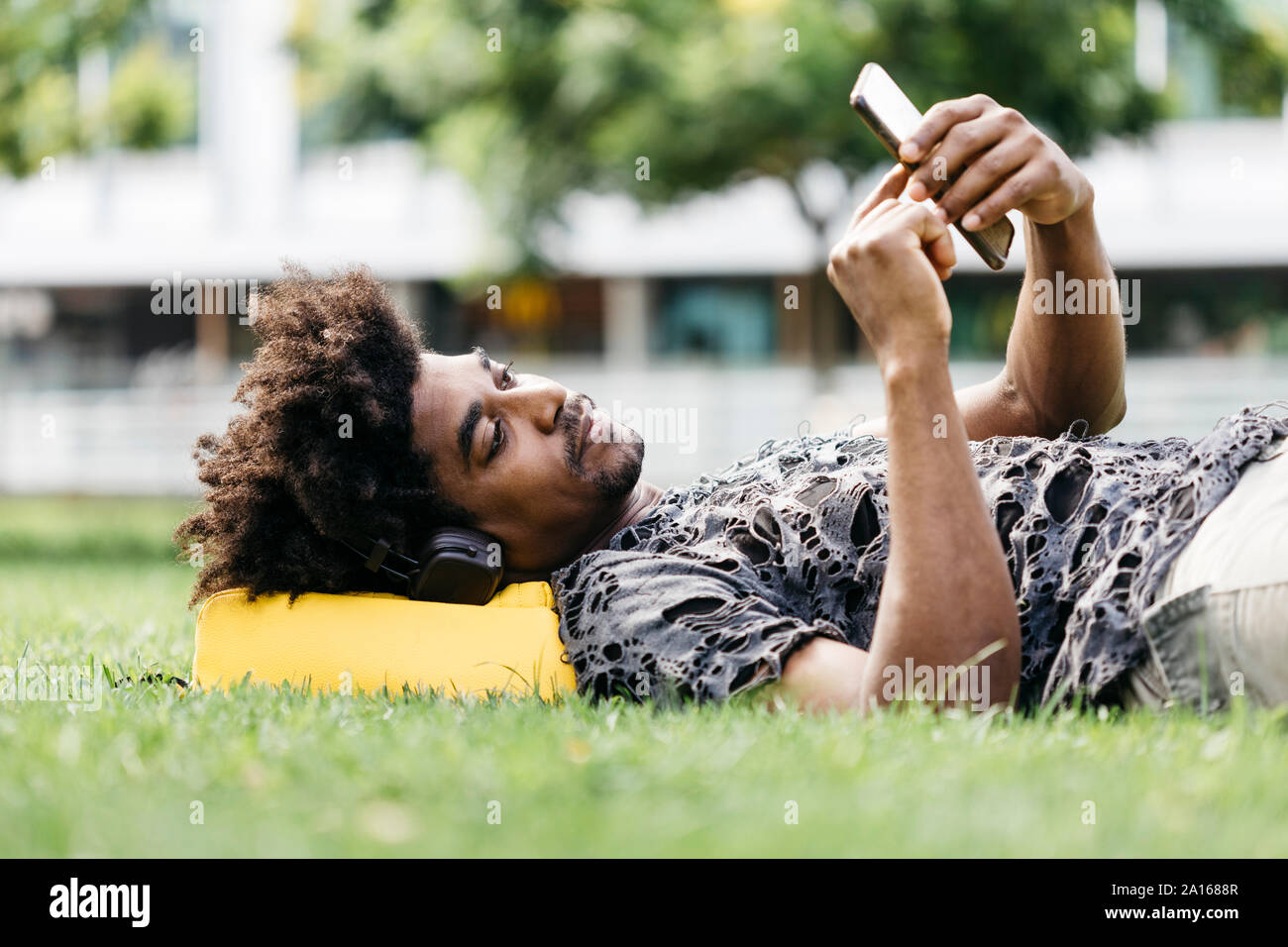 Man listening music lying on hi-res stock photography and images - Alamy