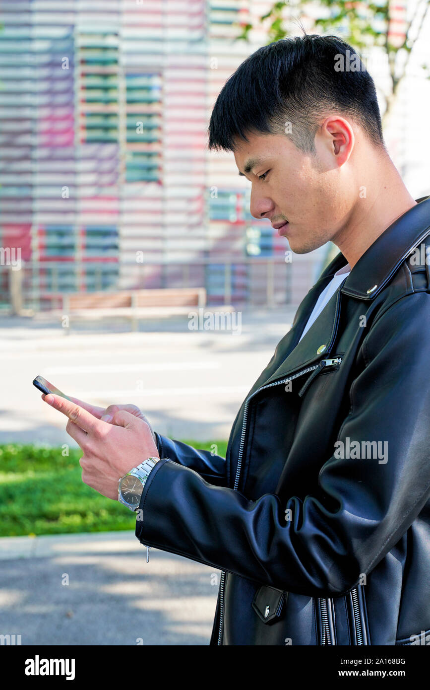Young man using cell phone, Barcelona, Spain Stock Photo - Alamy