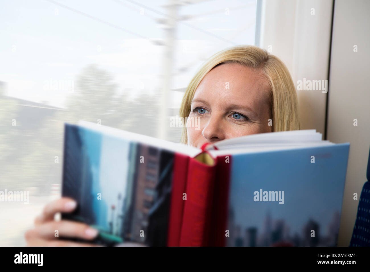 Woman reading in train hi-res stock photography and images - Alamy