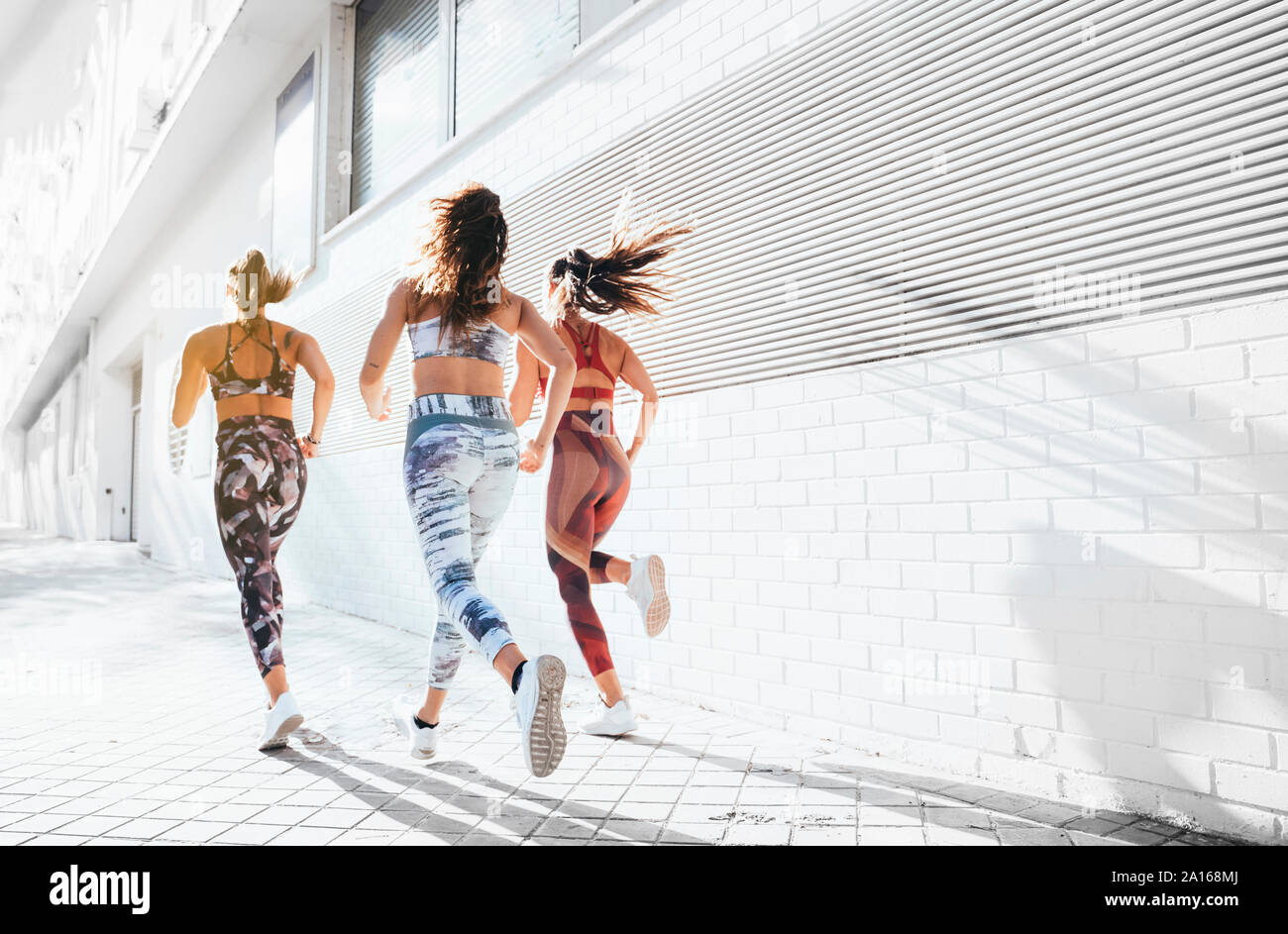 Three women friends rear hi-res stock photography and images - Alamy