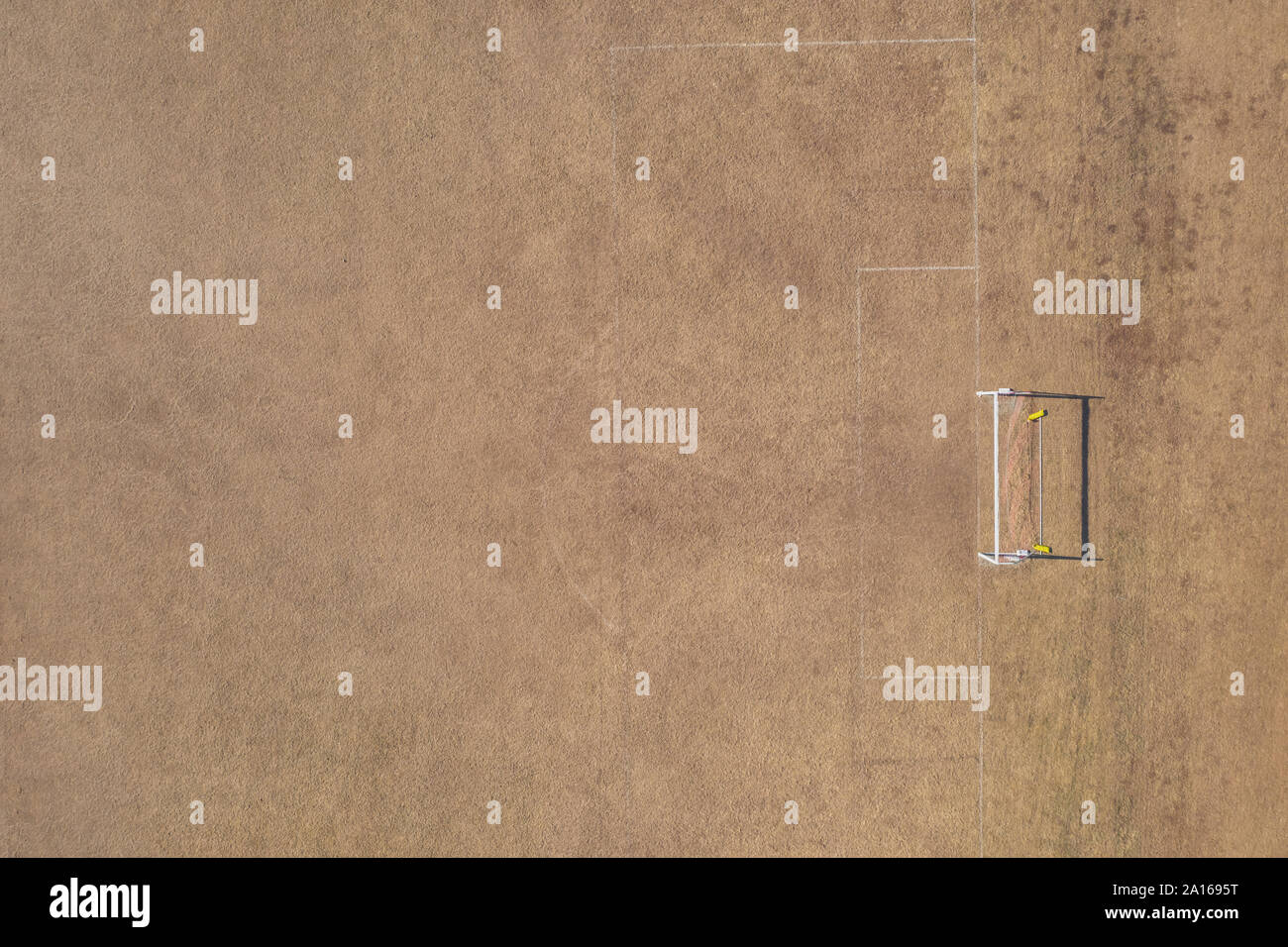 Aerial view of goal post on dry soccer field in summer during drought ...