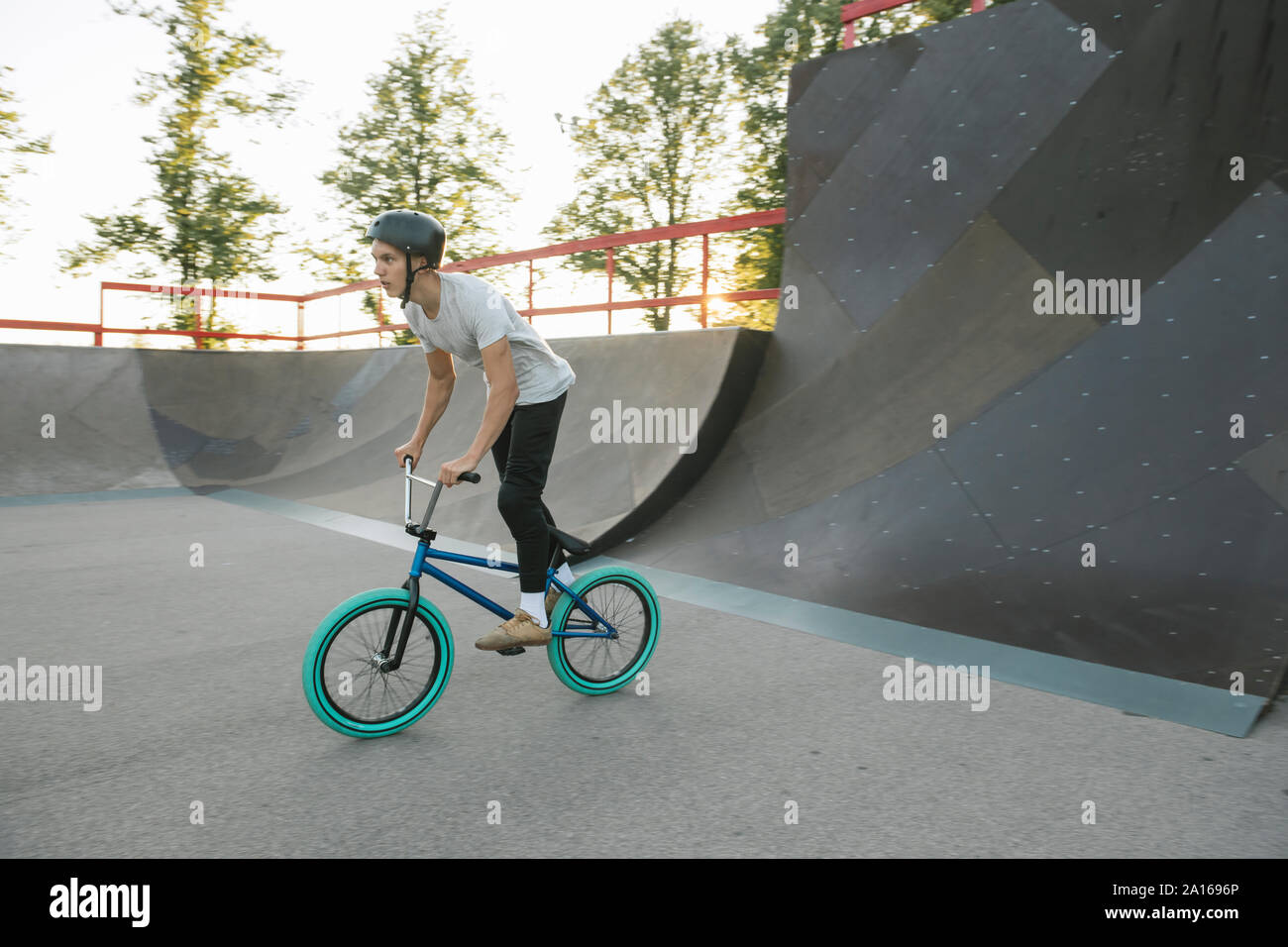 Young man riding BMX bike at skatepark Stock Photo - Alamy