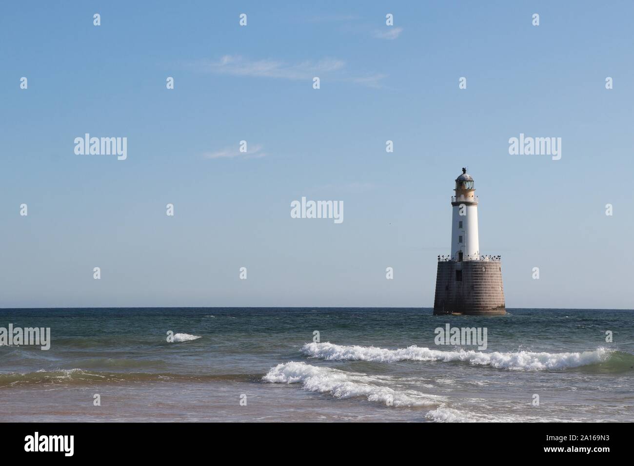 White lighthouse on platform in sea Stock Photo - Alamy