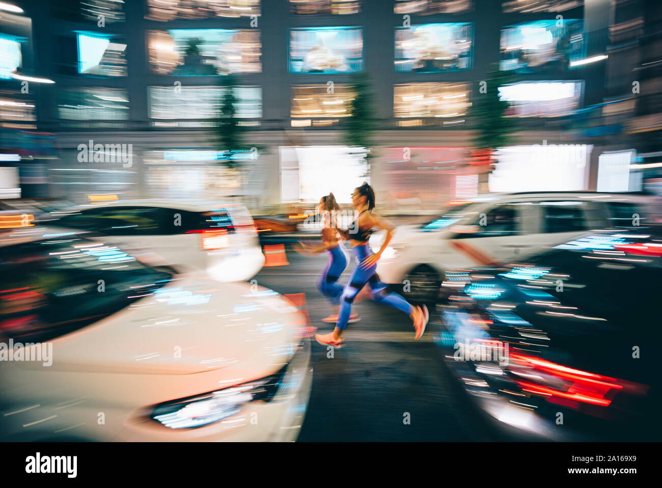 Long exposure photo of two women running through the streets in the ...