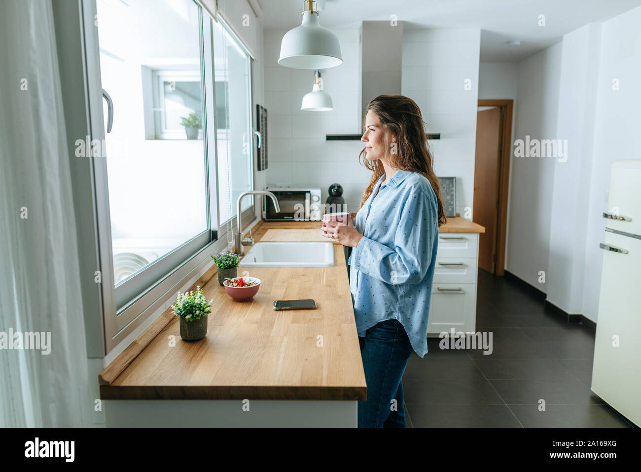 Woman in her kitchen hi-res stock photography and images - Alamy
