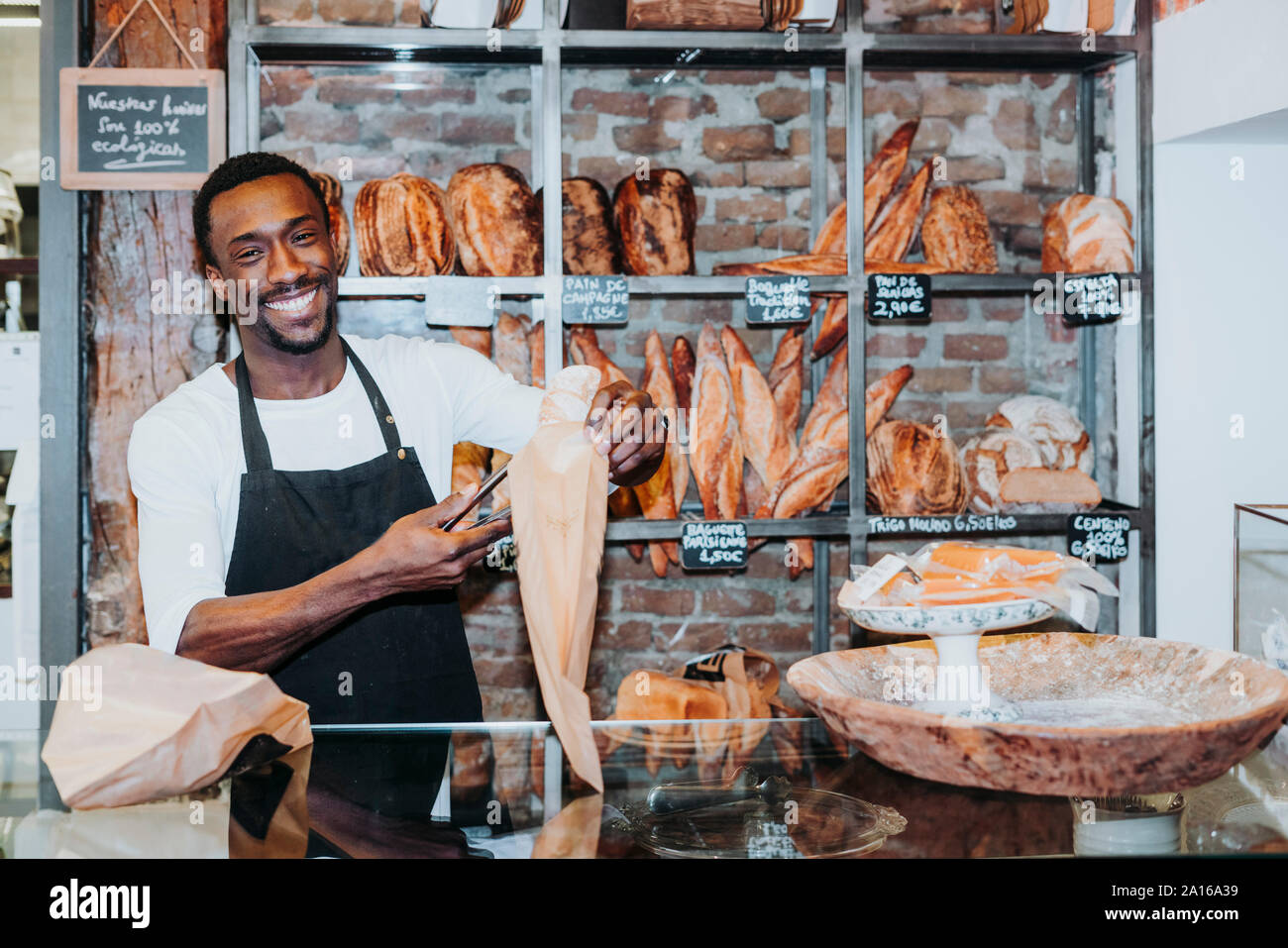 Smiling man serving bread hi-res stock photography and images - Alamy