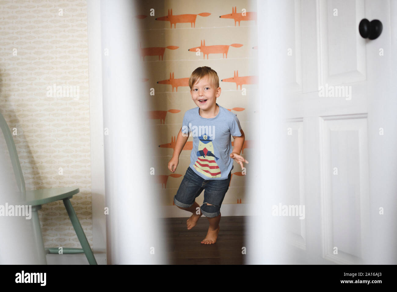 Happy boy running at home Stock Photo - Alamy