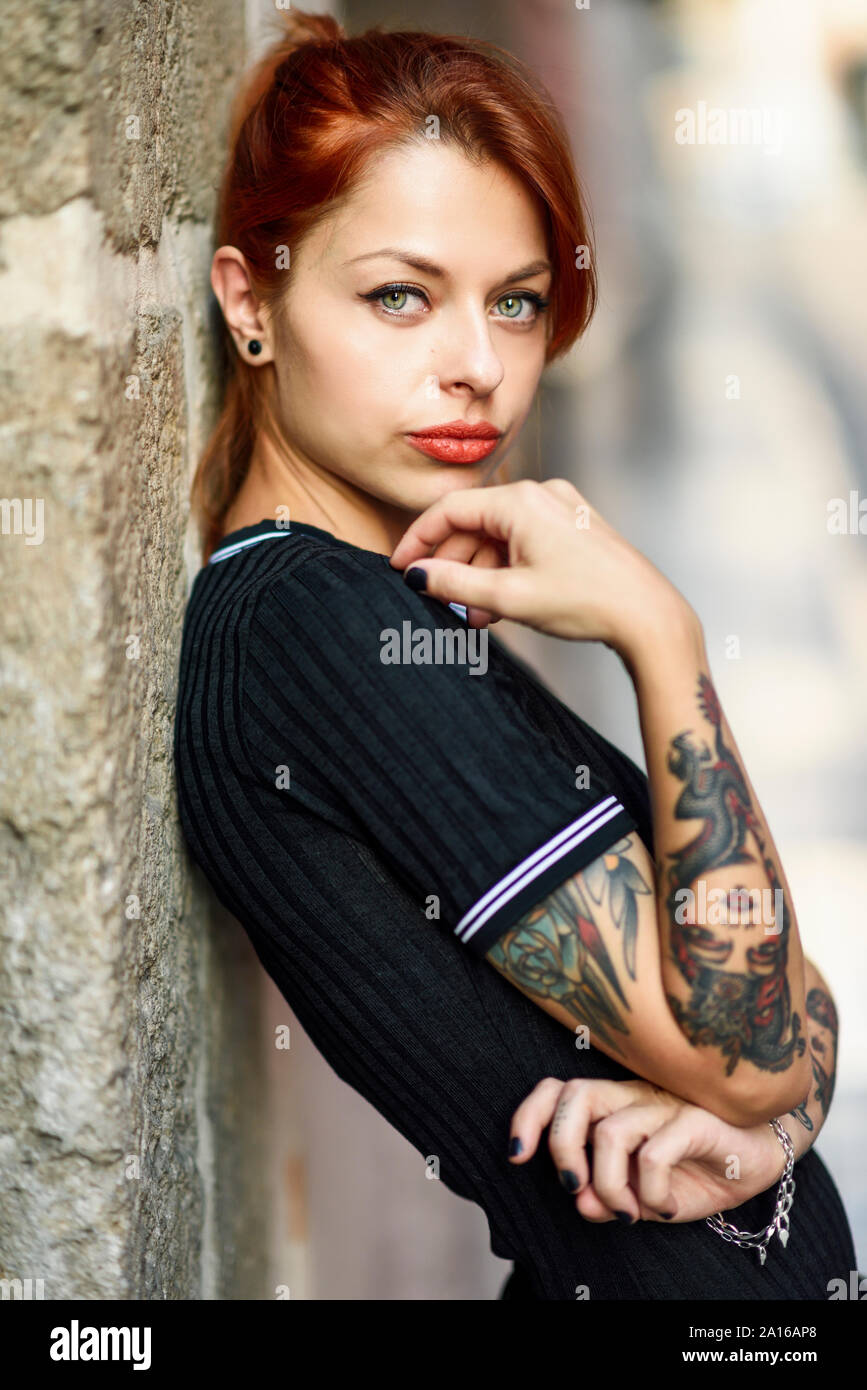 Portrait of red-haired tattooed woman outdoors Stock Photo - Alamy