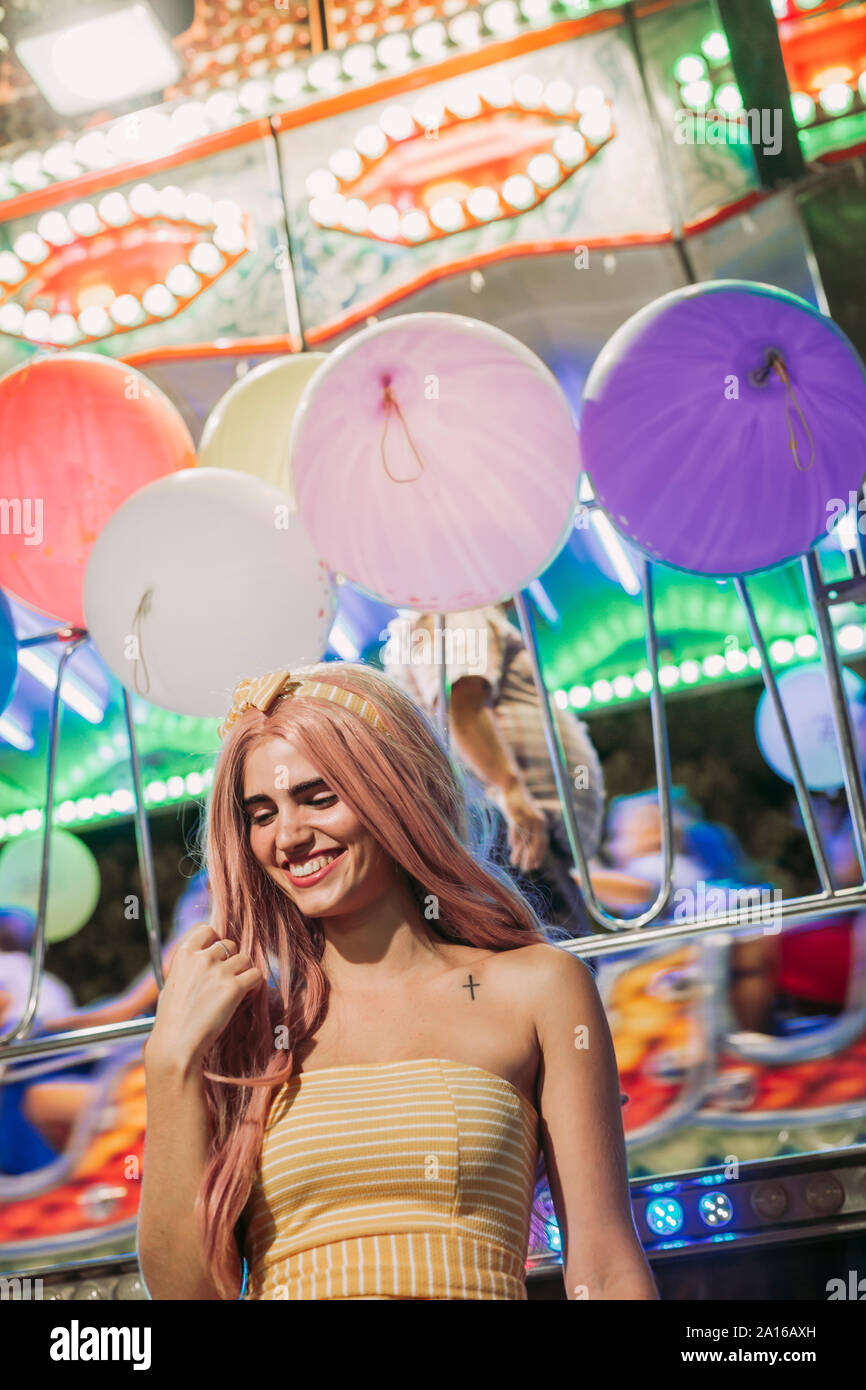 Happy young woman on a funfair at night Stock Photo - Alamy