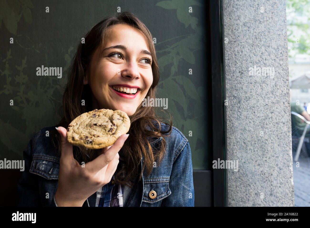 Woman eating chocolate biscuit hi-res stock photography and images - Alamy