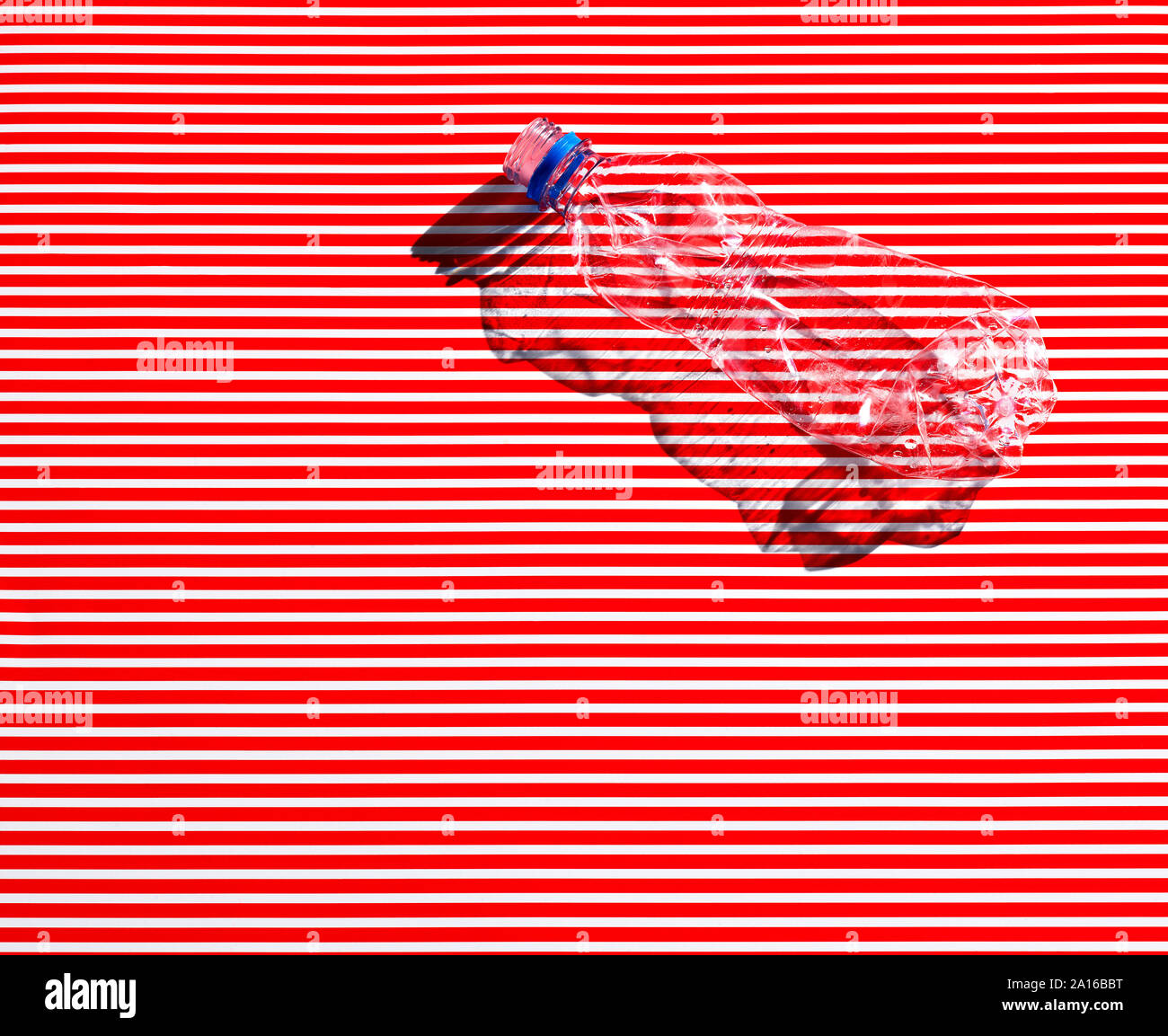 Plastic bottles on red white striped background Stock Photo - Alamy