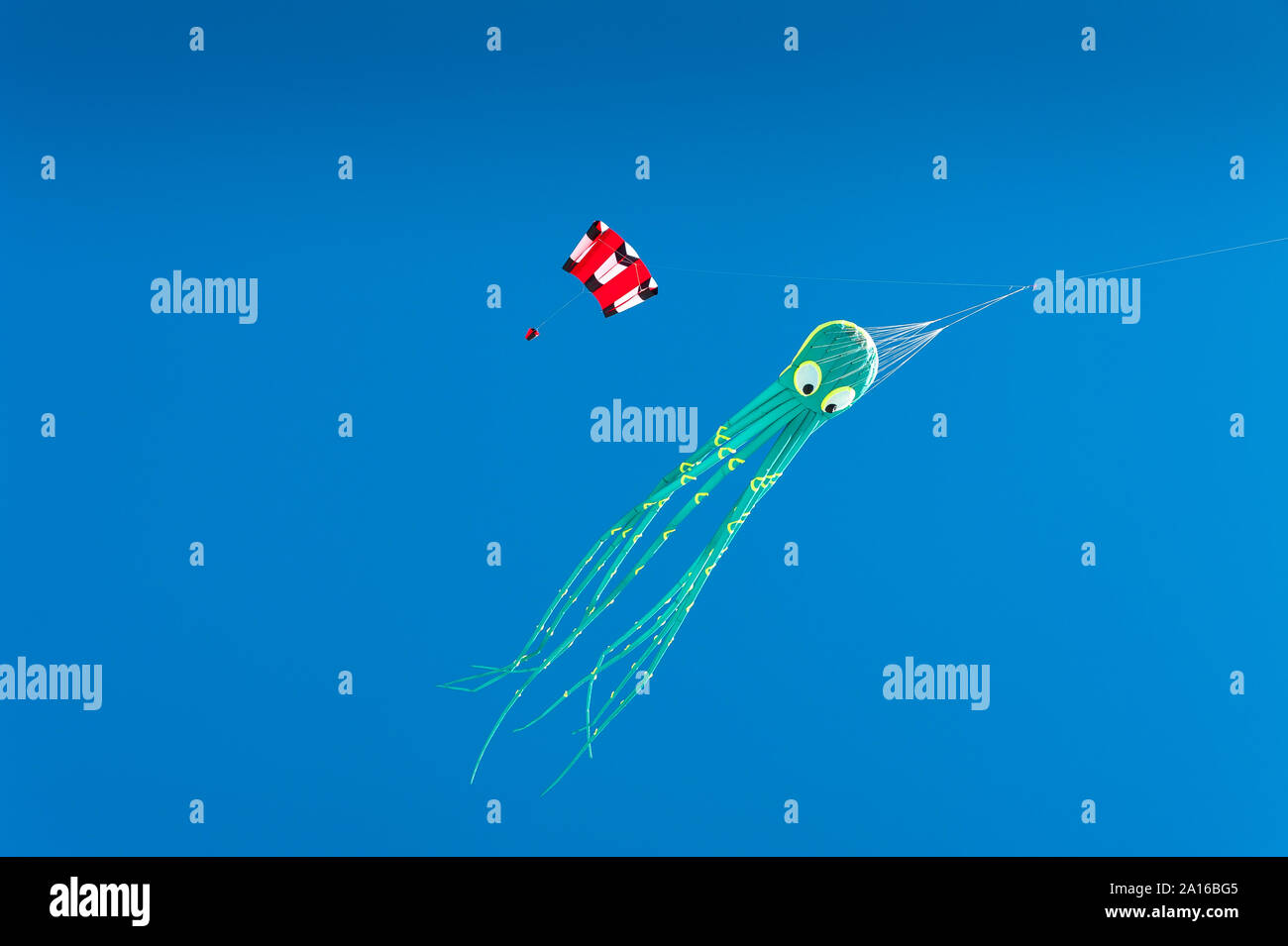 Two kites in blue sky Stock Photo - Alamy