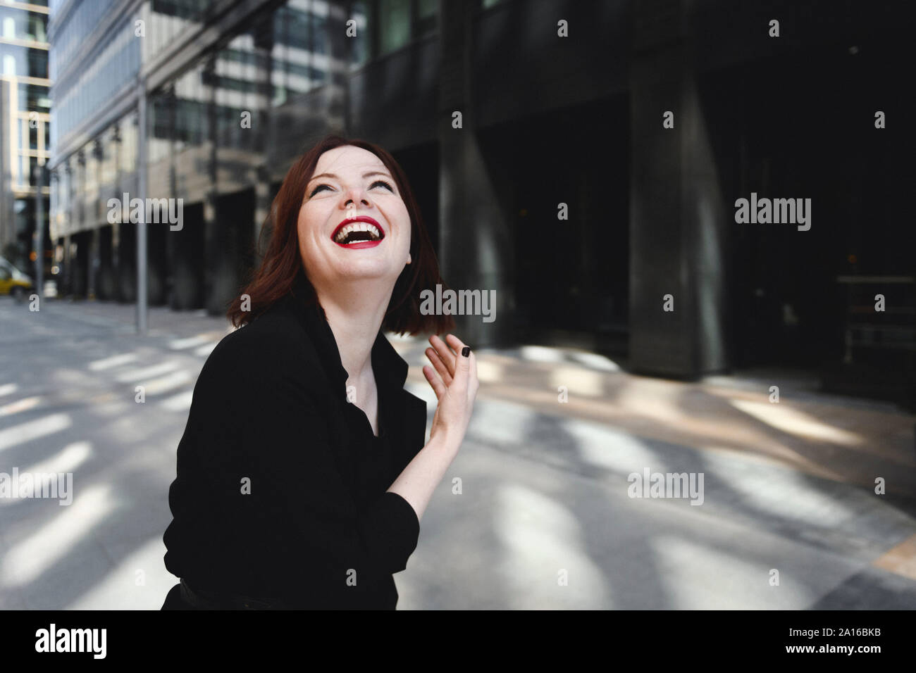 Happy woman strolling in the city Stock Photo - Alamy