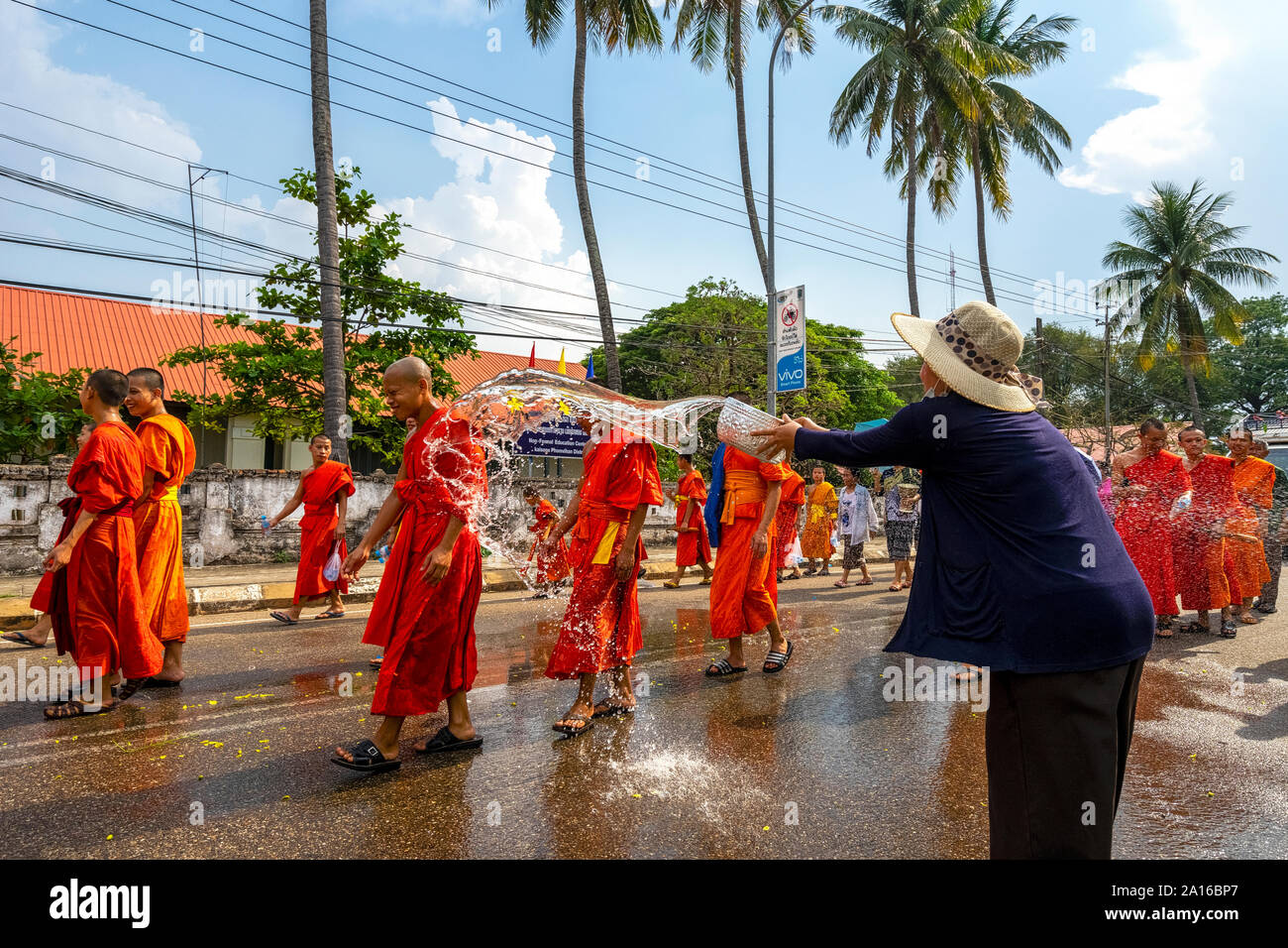 Beautiful Asian woman and man in Laos traditionally splashing water ...