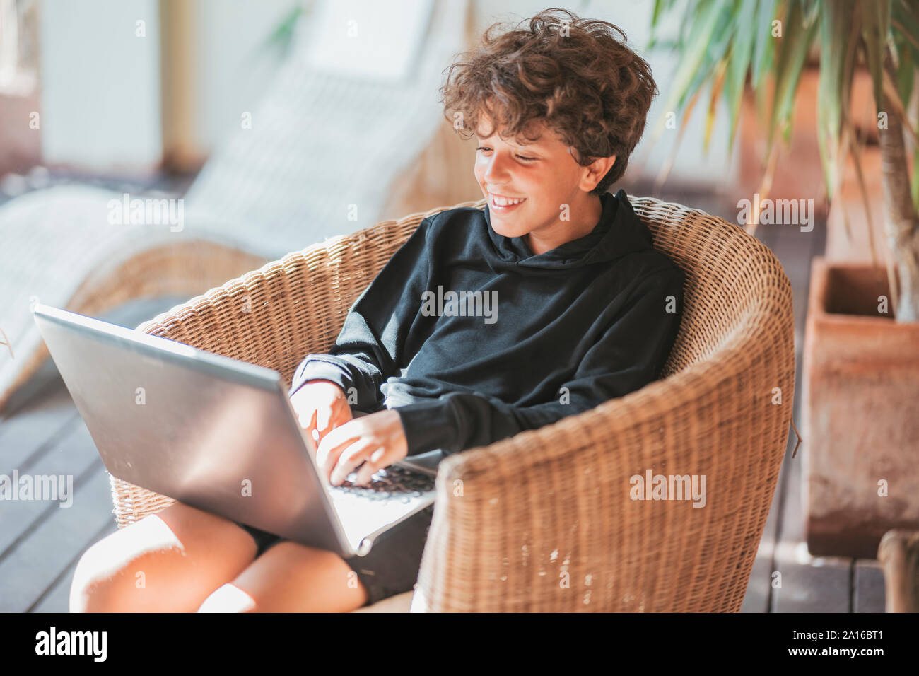 Boy sitting at computer typing hi-res stock photography and images - Alamy
