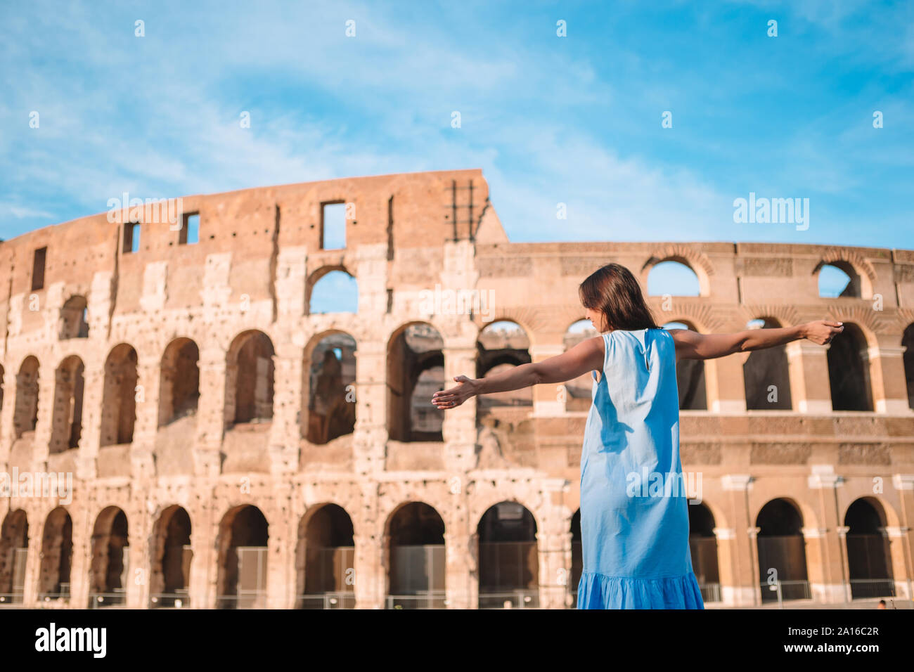 Young female tourist looking at the Colosseum outside in Rome, Italy ...