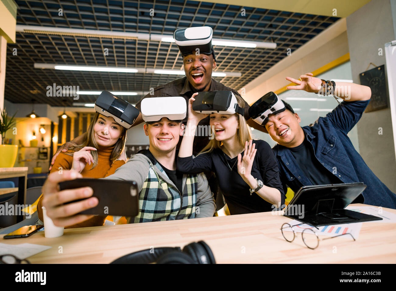 Young group of multiethnical people having fun with vr headset ...