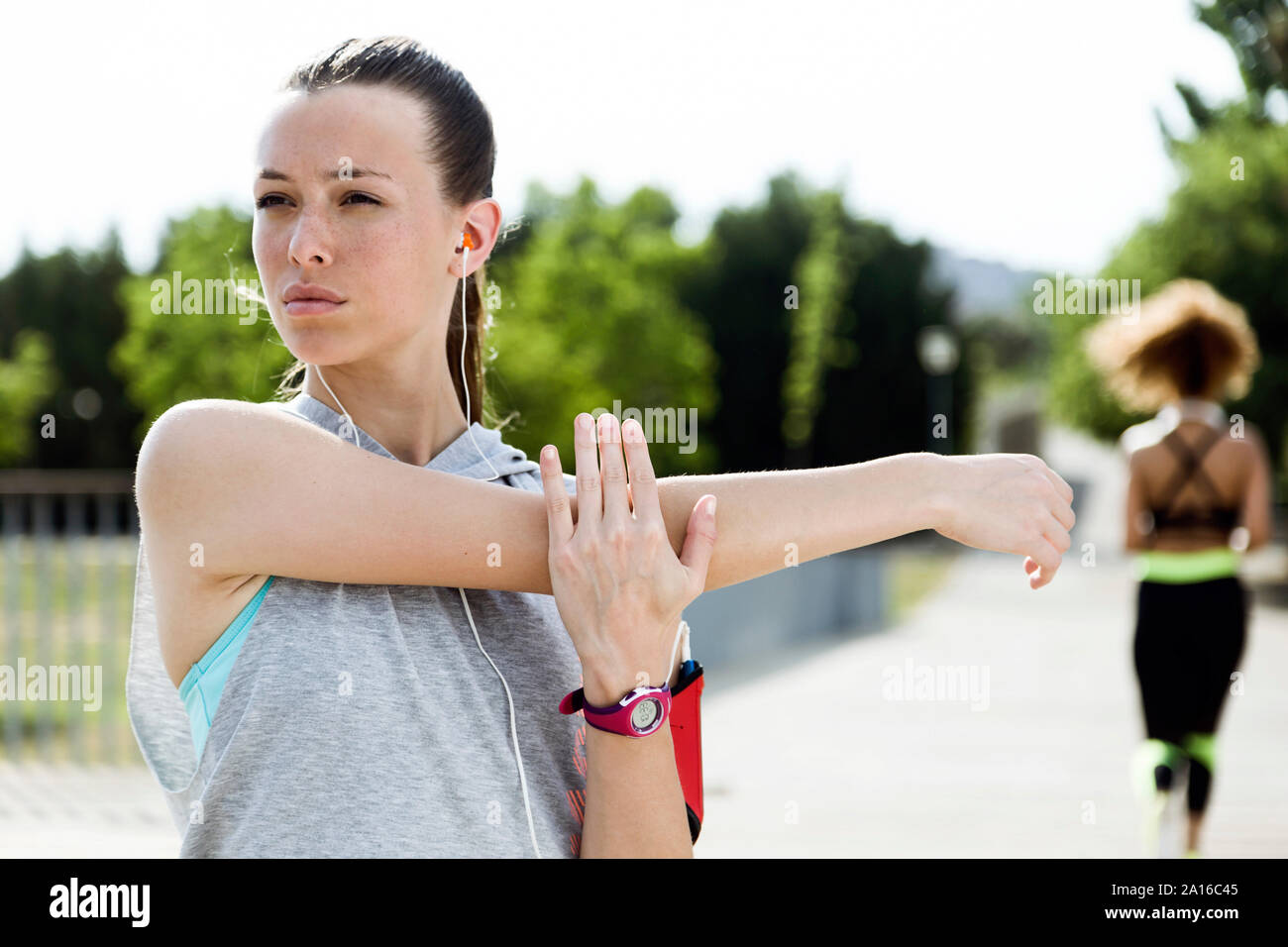 Sporty teenage girl doing stretching exercise Stock Photo - Alamy