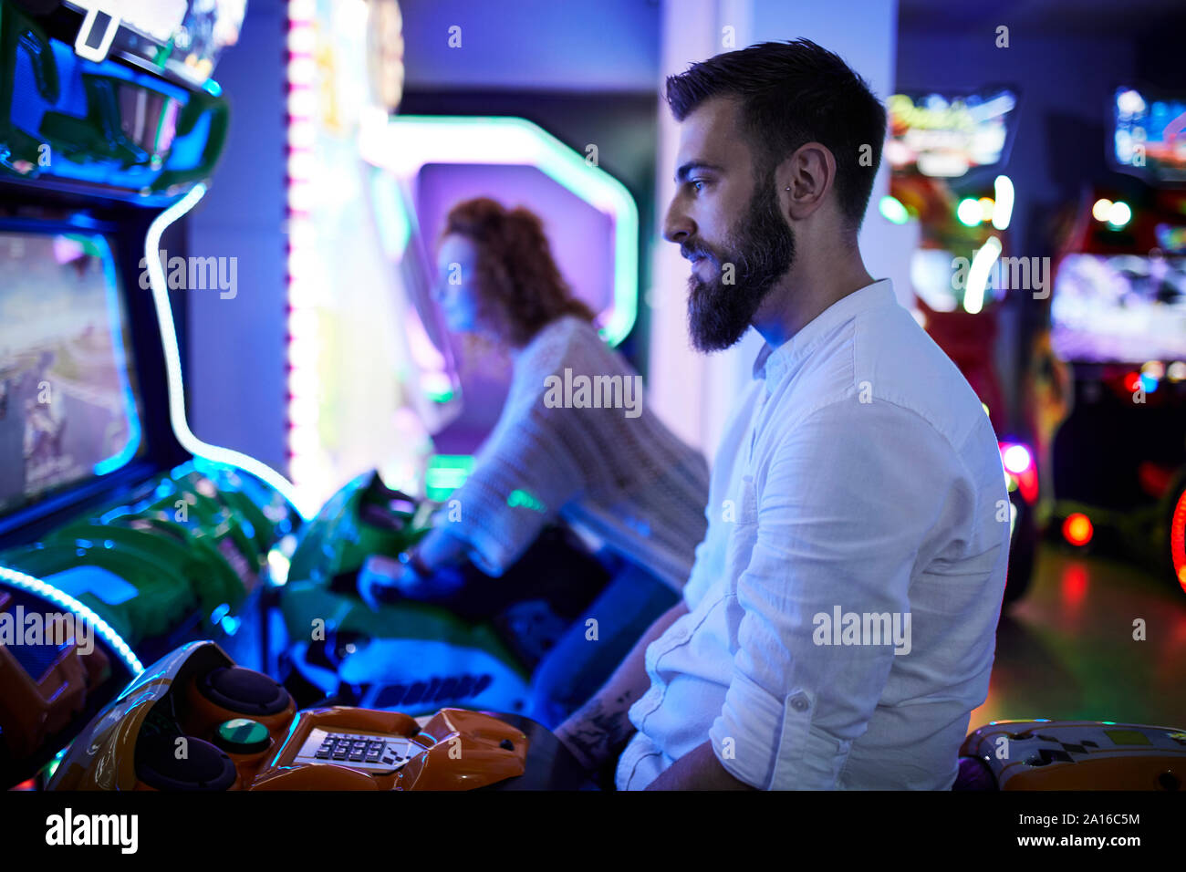 Man at a driving simulator in an amusement arcade Stock Photo - Alamy