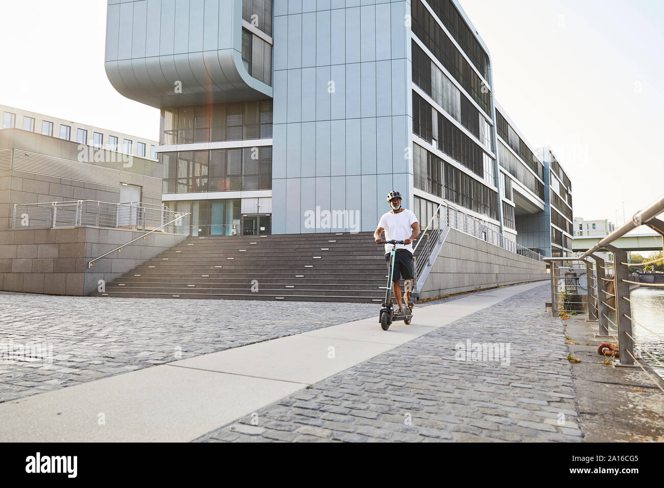 Modern man riding scooter hi-res stock photography and images - Alamy
