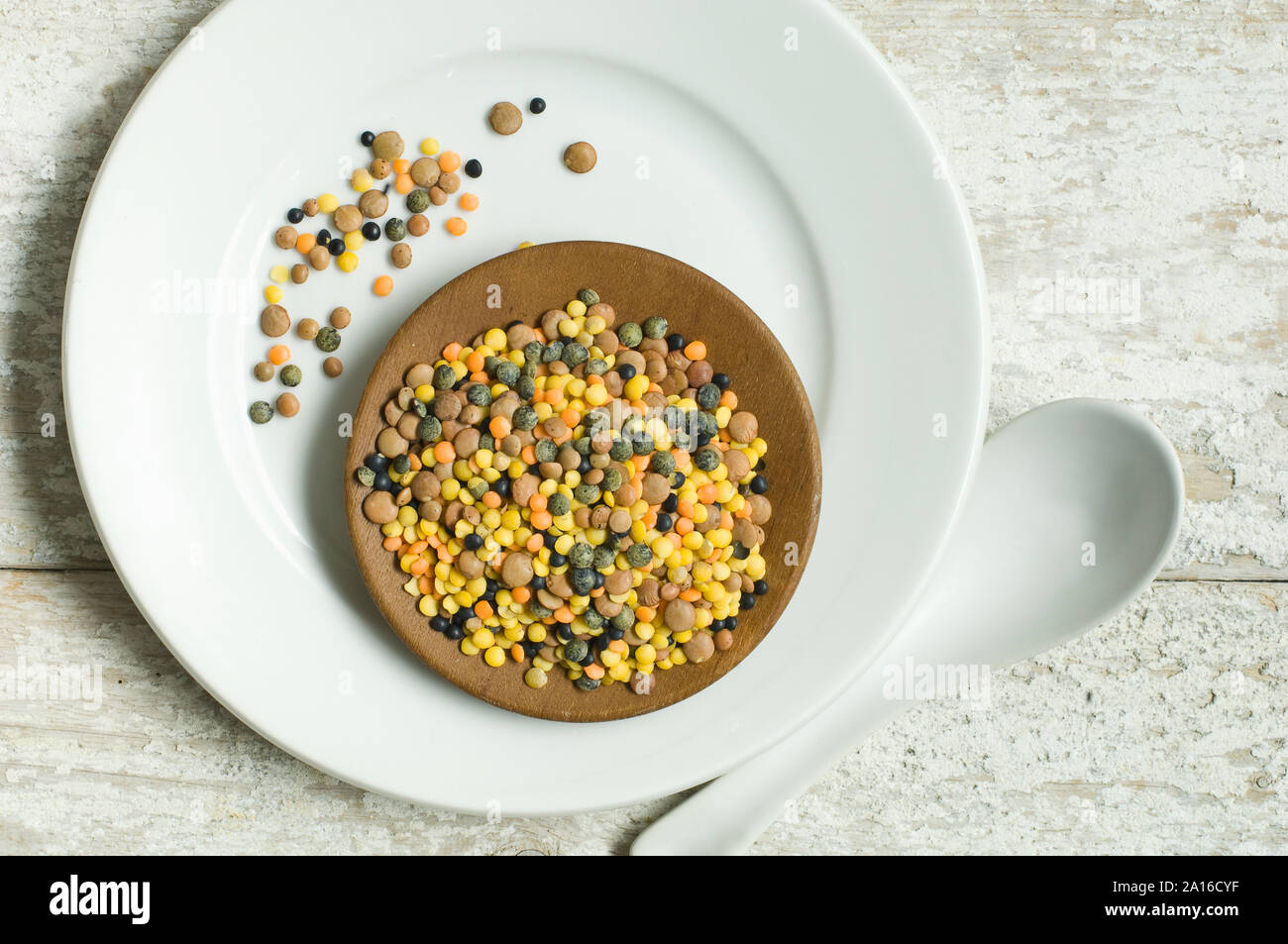 Plate of lentils on wooden table seen from above Stock Photo - Alamy