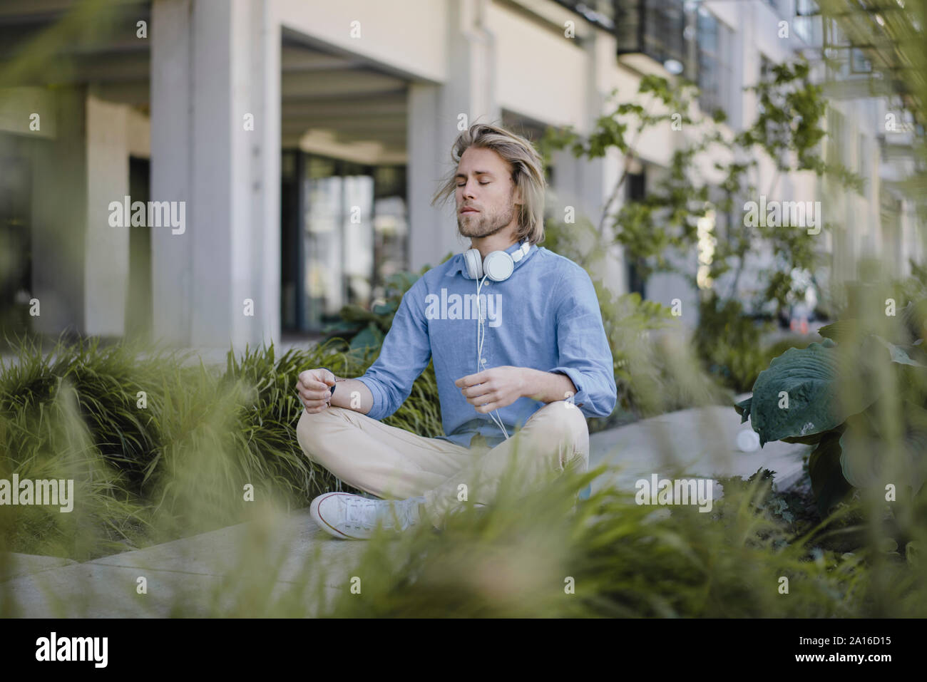 Young man sitting outside building hi-res stock photography and images ...