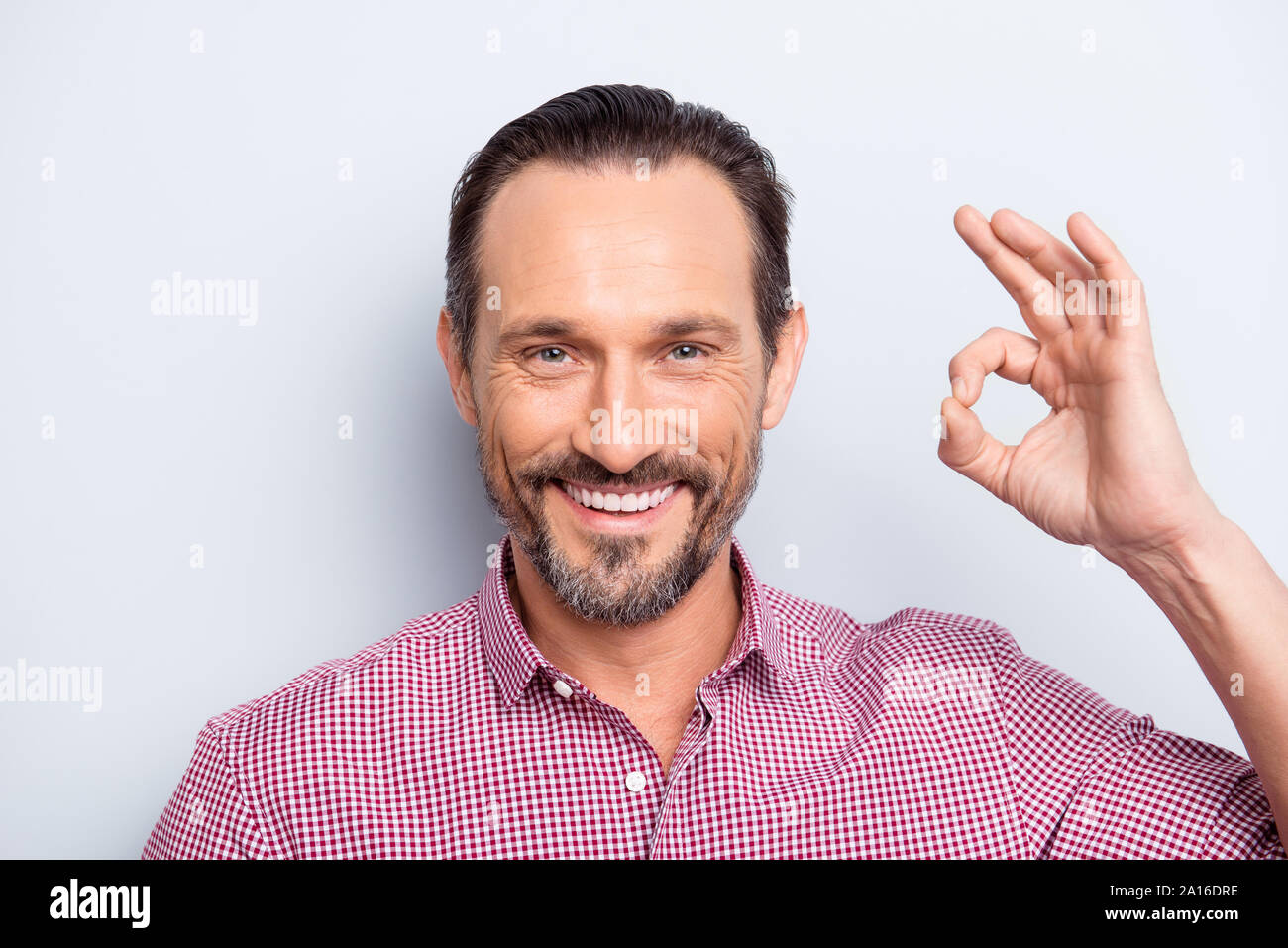 Portrait of good-looking man look at camera stand isolated on li Stock ...