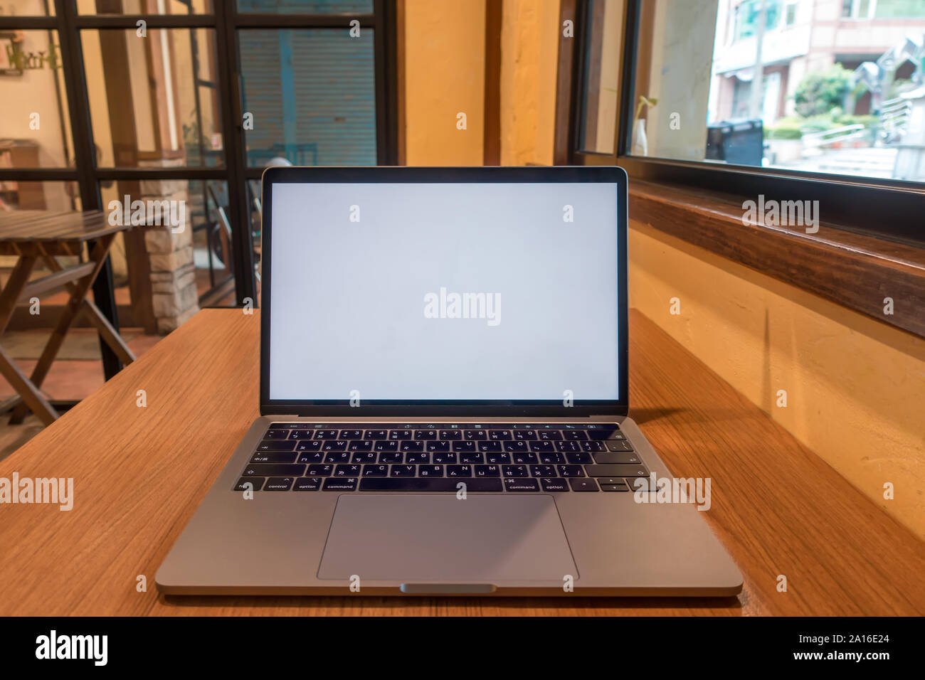 Conceptual workspace, Laptop computer with blank white screen on table ...