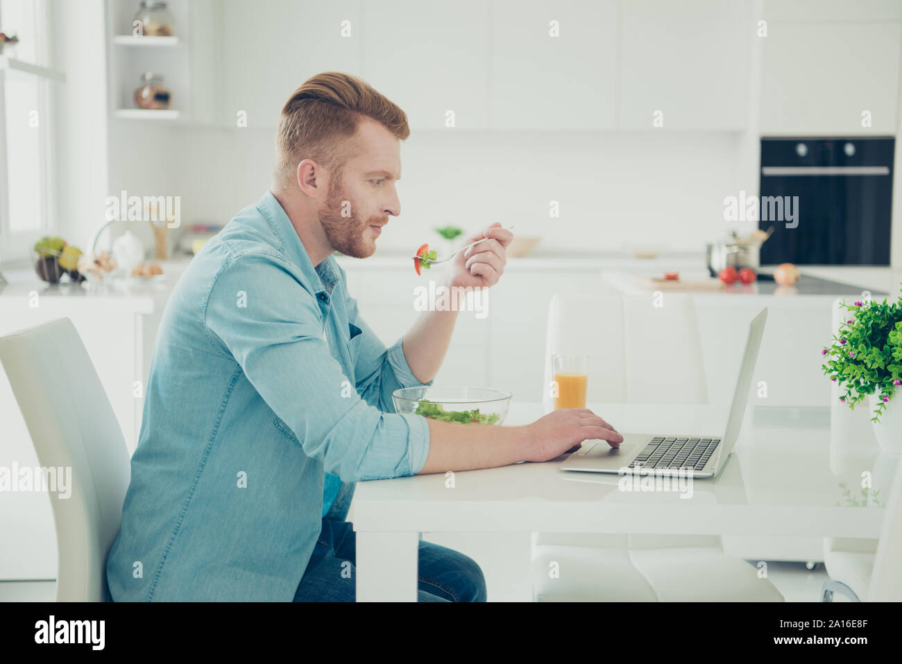 Calm attractive good-looking man look on pc gadget screen sit on Stock ...