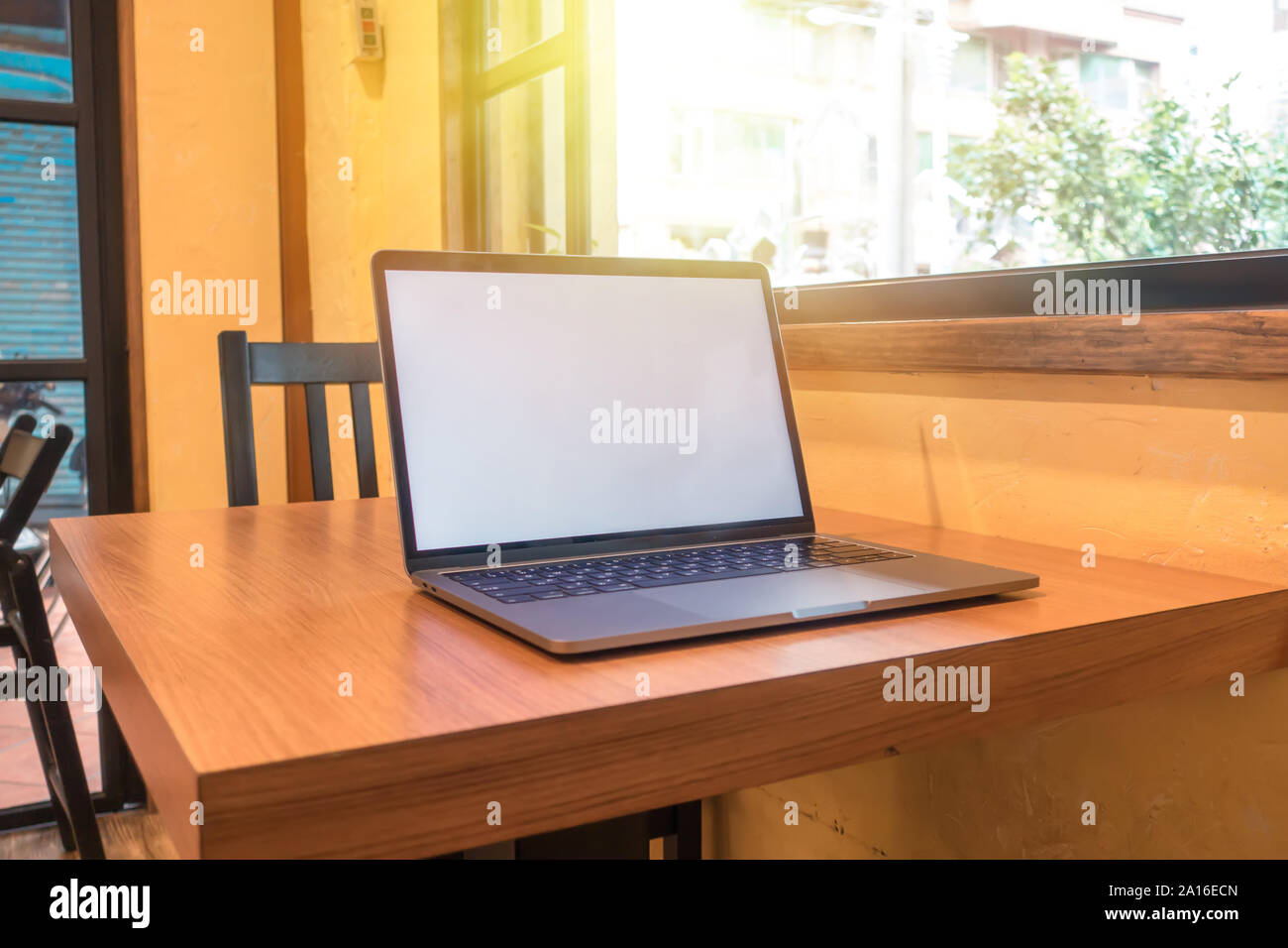 Conceptual workspace, Laptop computer with blank white screen on table ...