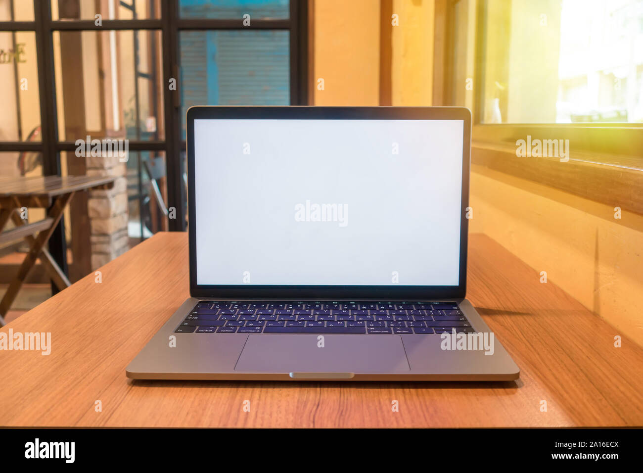 Conceptual workspace, Laptop computer with blank white screen on table ...