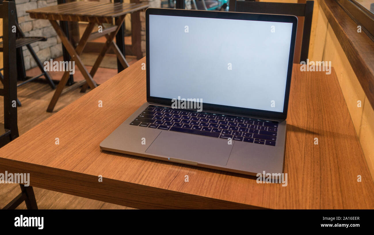 Conceptual workspace, Laptop computer with blank white screen on table ...